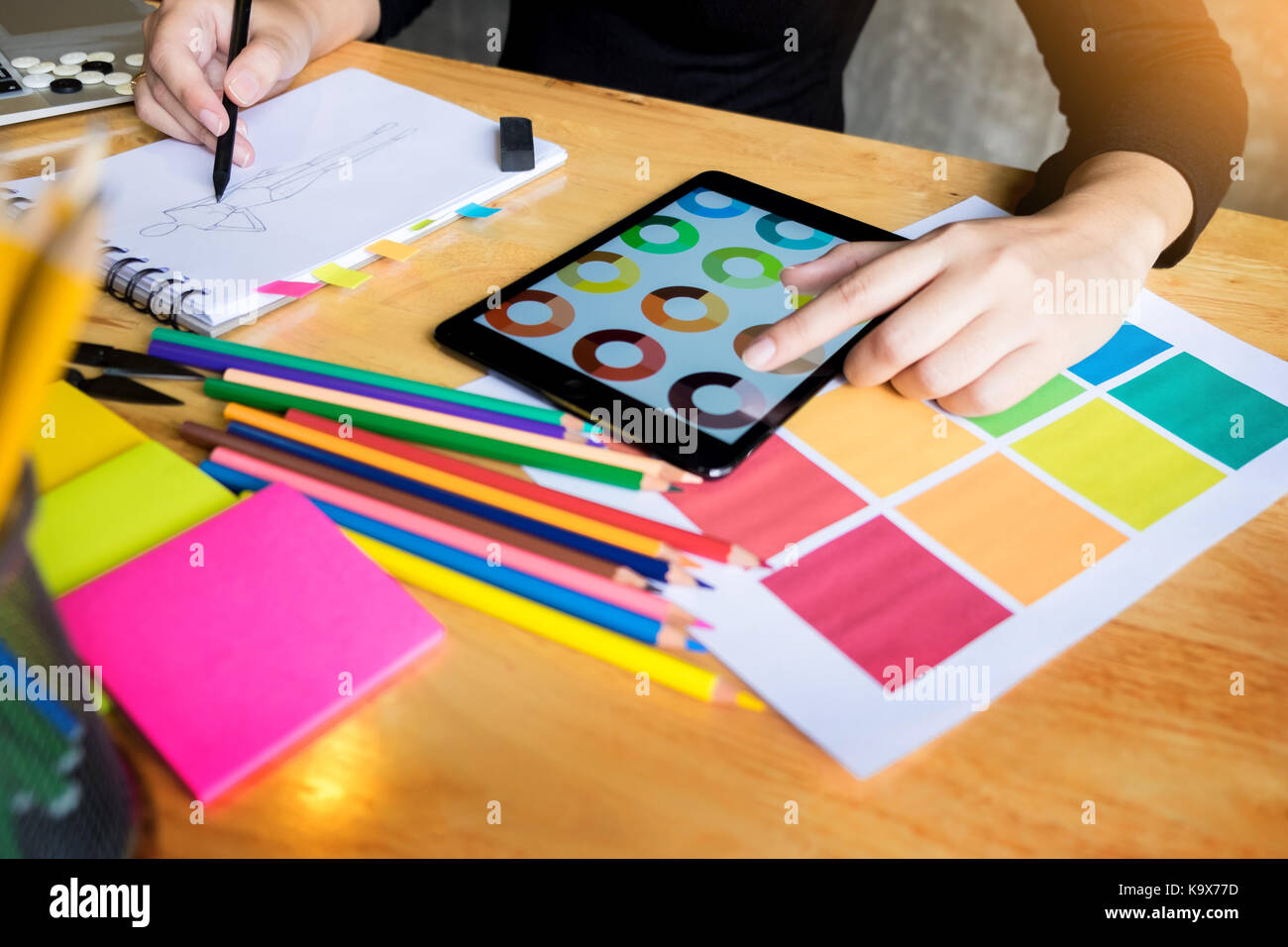 women working as fashion designer choosing on colour chart for clothes ...