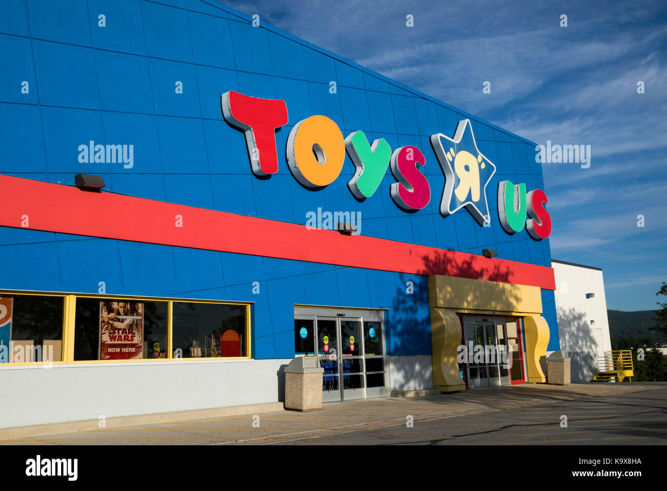 A logo sign outside of a Toys "R" Us retail store in Frederick ...