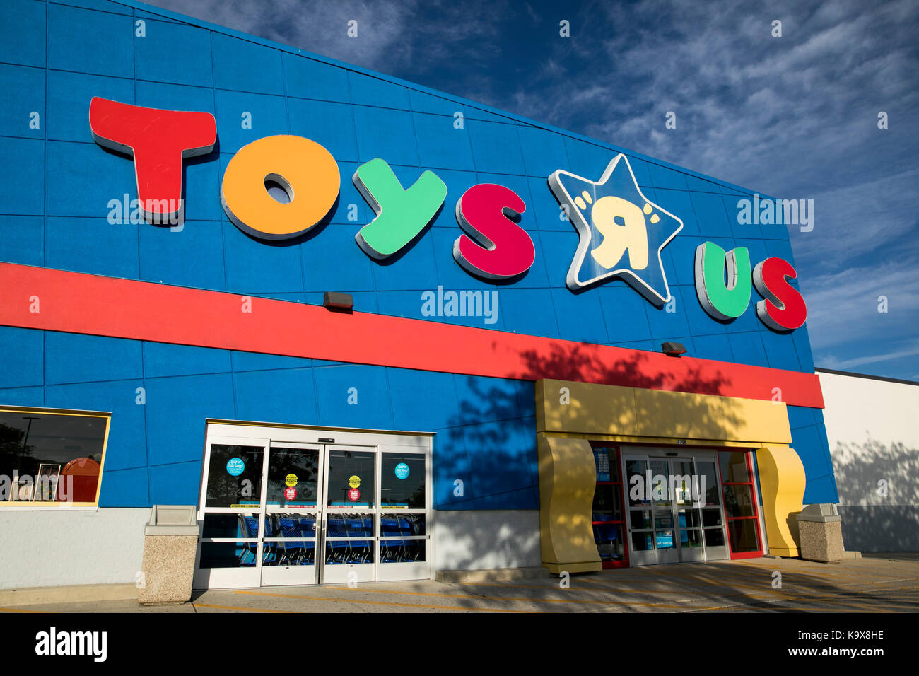 A logo sign outside of a Toys "R" Us retail store in Frederick ...