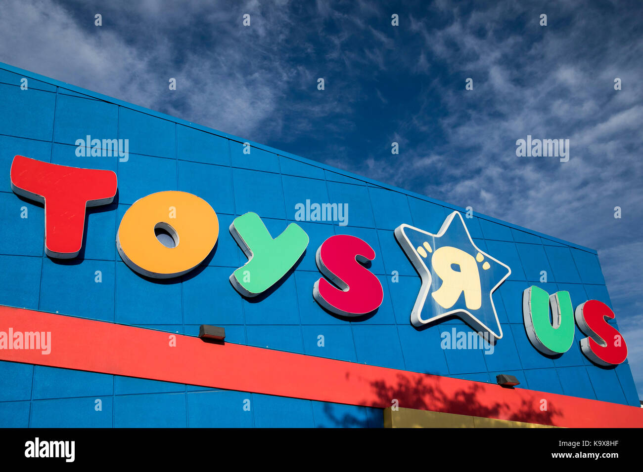 A logo sign outside of a Toys "R" Us retail store in Frederick ...