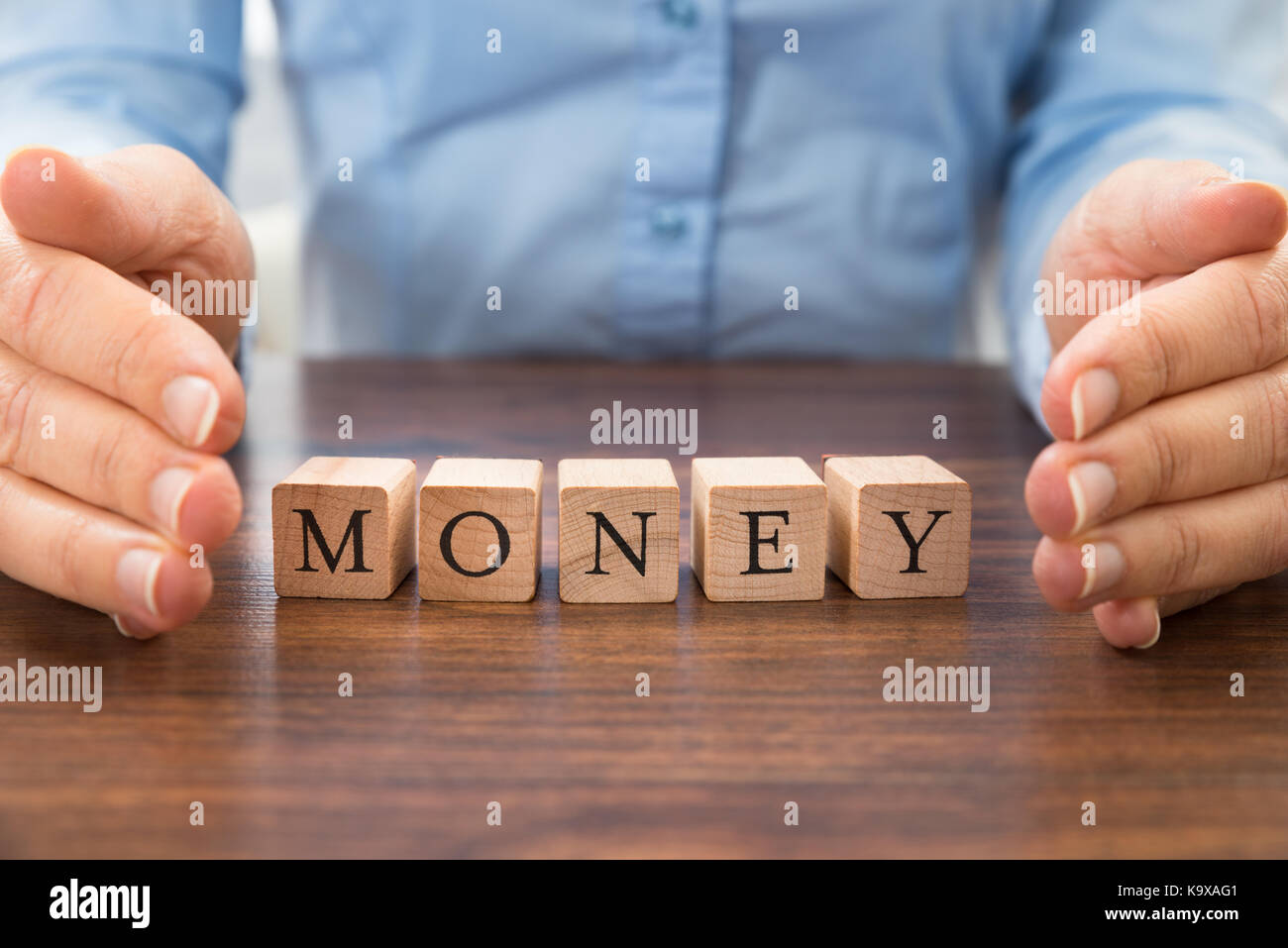 Businessperson Saving The Word Money Made From Alphabet Blocks Stock ...