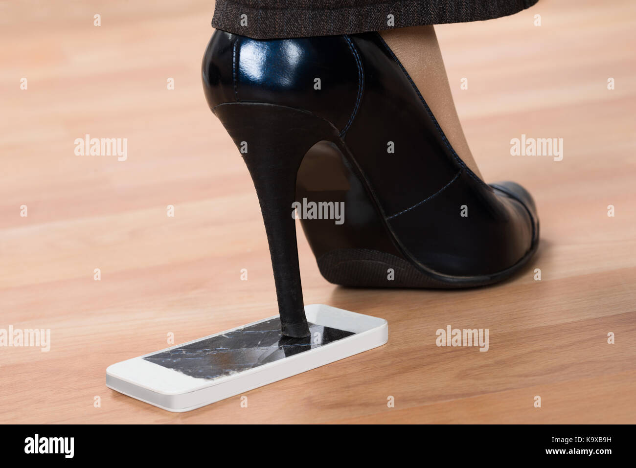 Close-up Of High Heel Step On Broken Screen Smartphone Stock Photo - Alamy