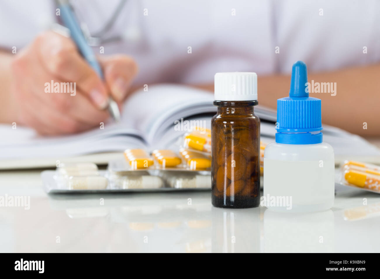 Doctor hand writing prescription on hi-res stock photography and images ...