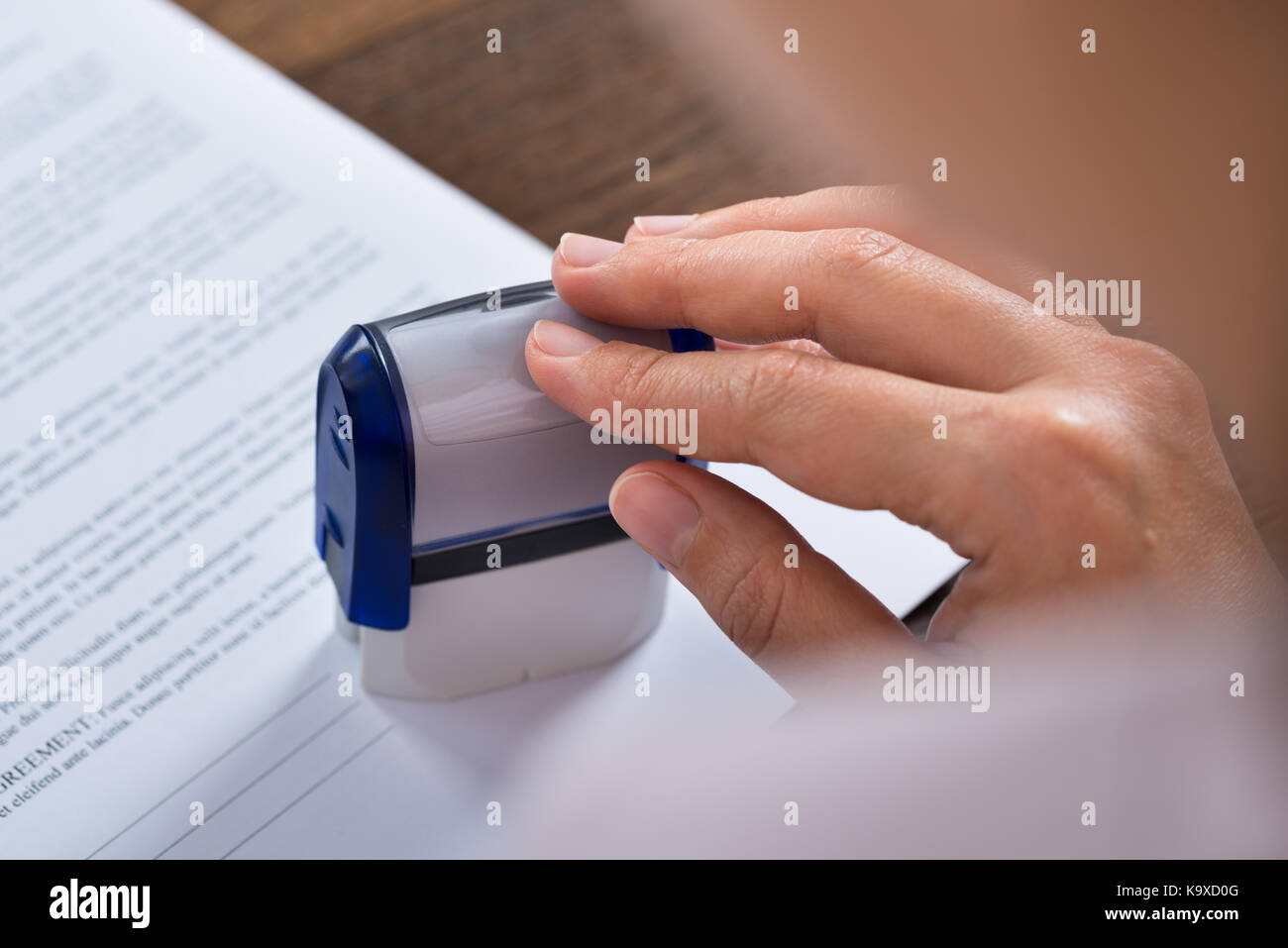 Close-up Of Person Hands Pressing Stamper On Document Stock Photo - Alamy