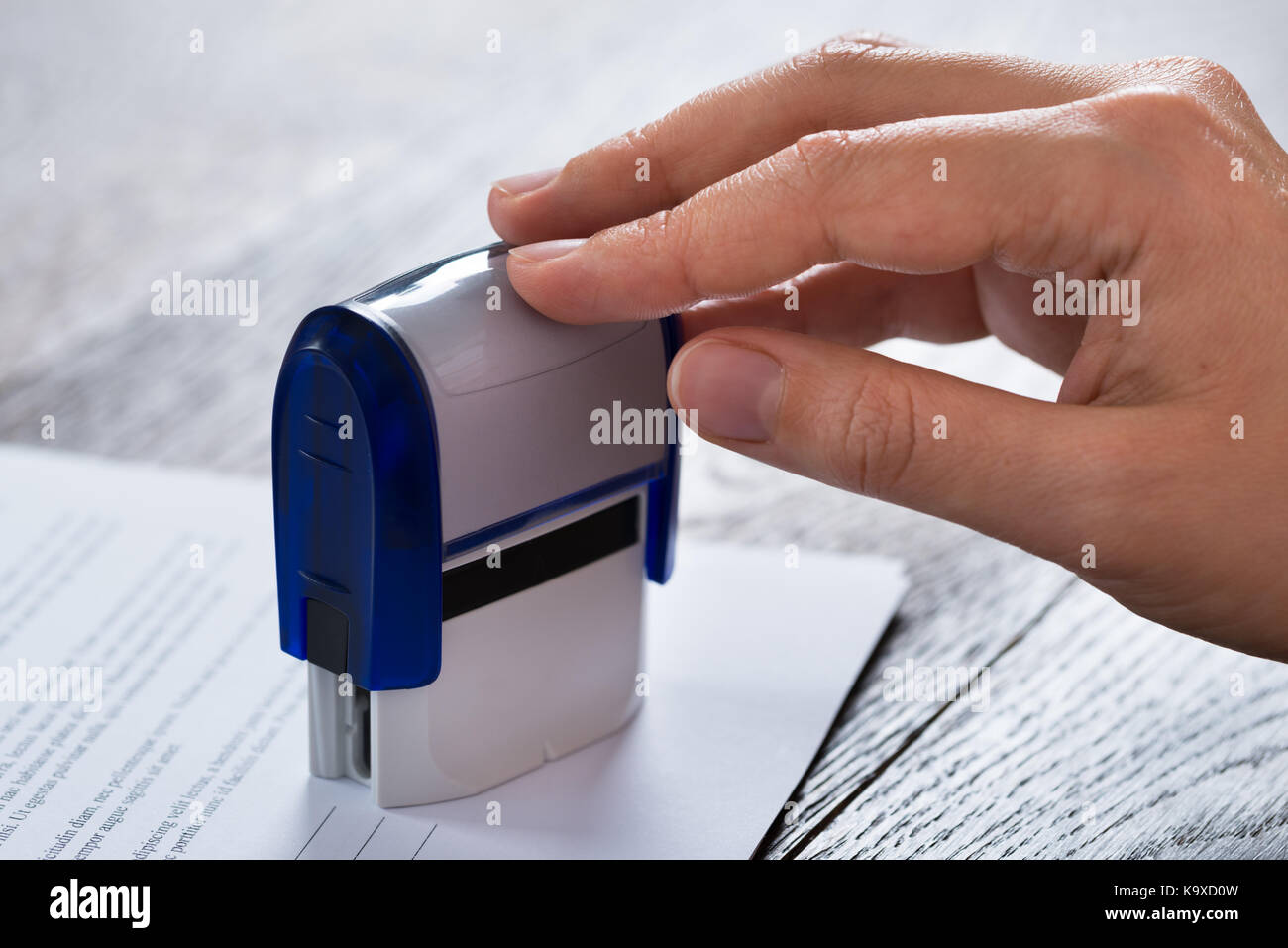 Close-up Of Person Hands Pressing Stamper On Document Stock Photo - Alamy