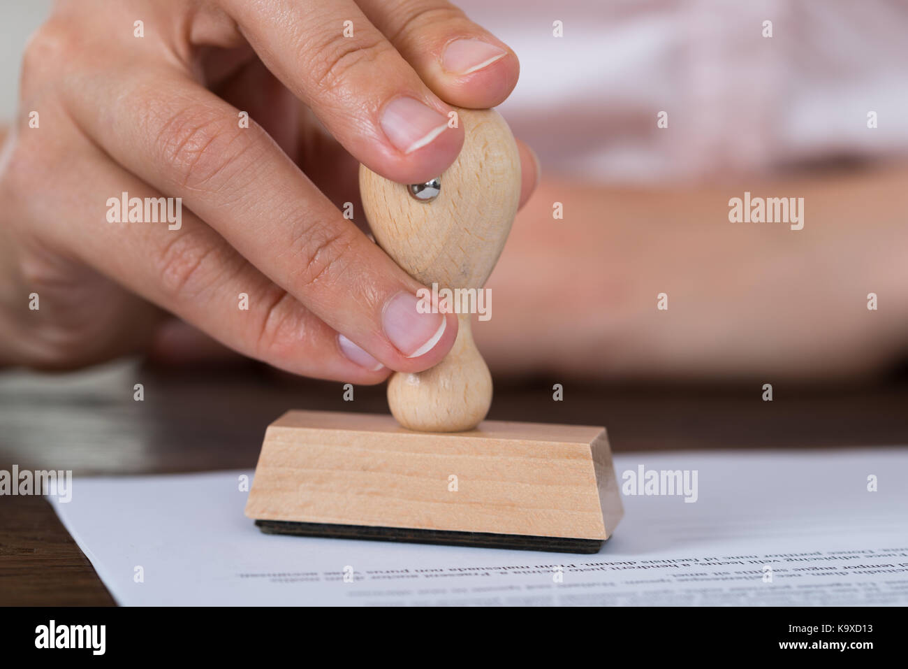 Close-up Of Person Hands Stamping Document At Desk Stock Photo - Alamy