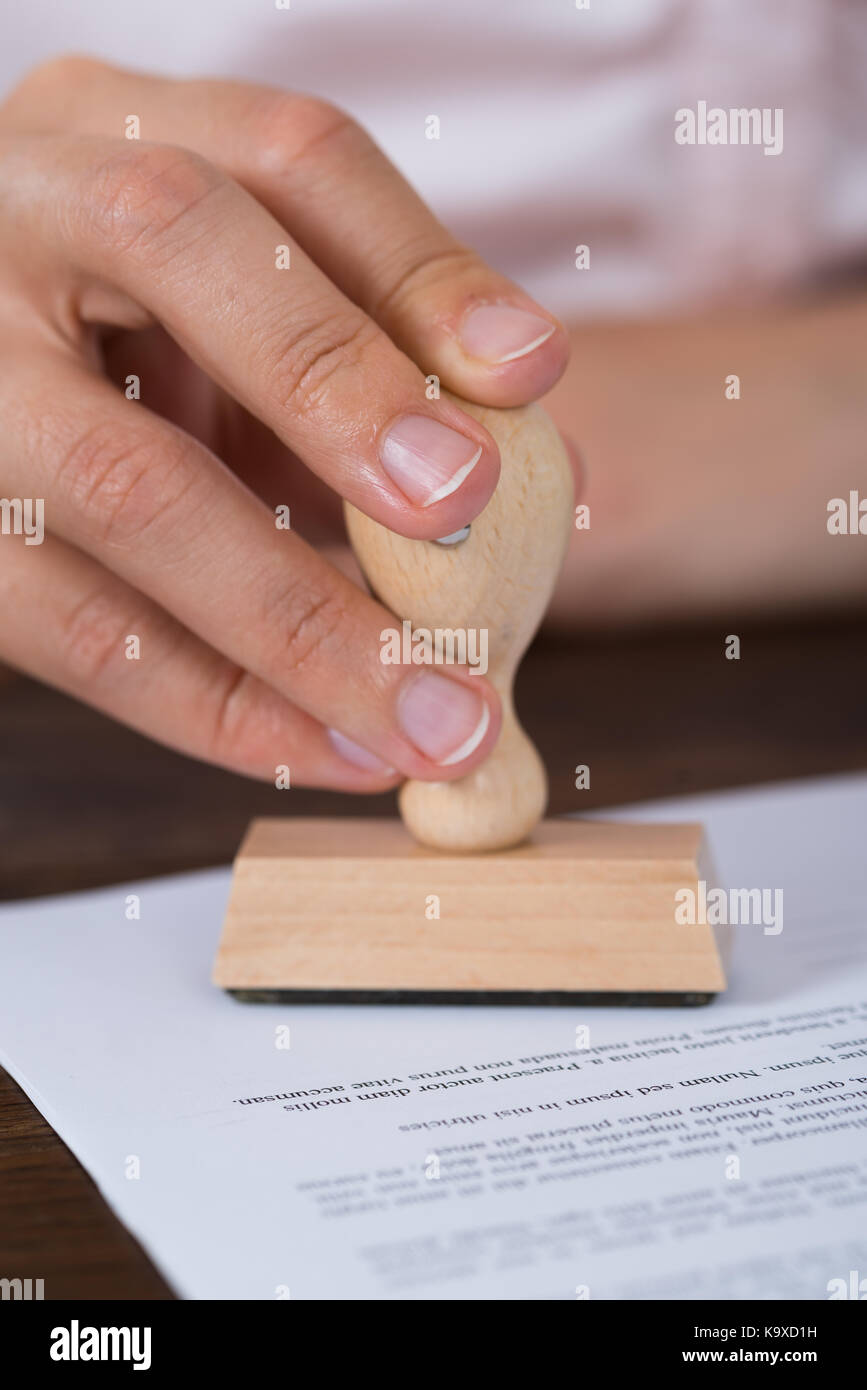 Close-up Of Person Hands Pressing Stamper On Document Stock Photo - Alamy