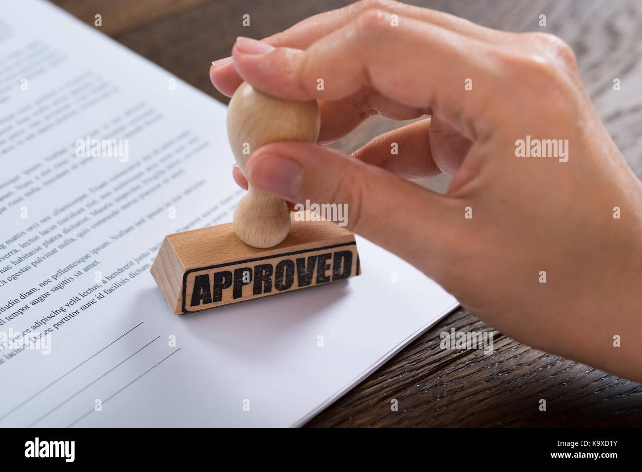 Close-up Of Person Hands Using Stamper On Document With The Text ...