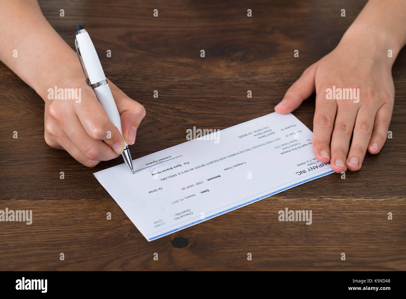 Close-up Photo Of Person Hands Signing Cheque Stock Photo - Alamy