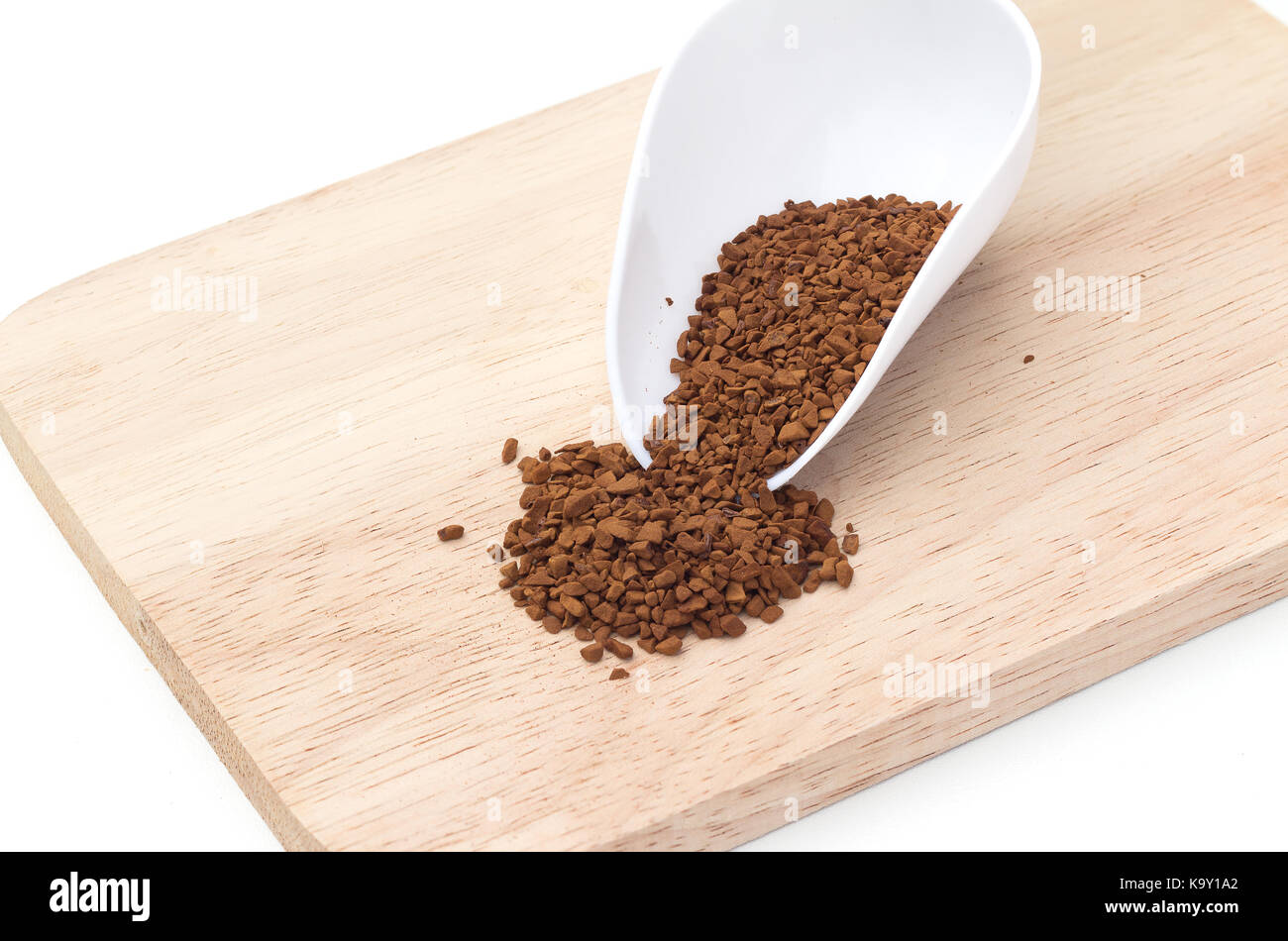 Instant coffee powder on wood plate and isolated on white background ...
