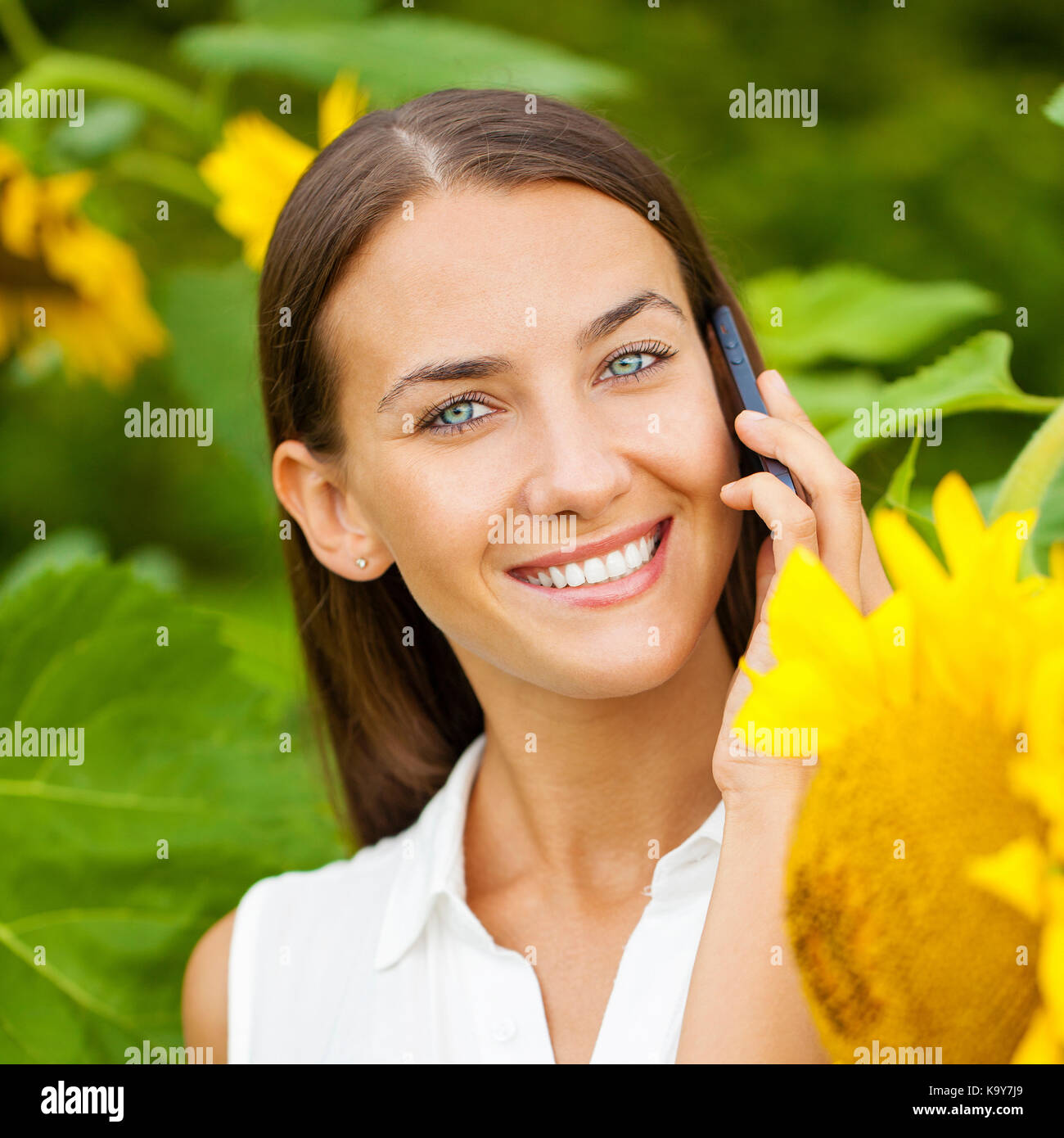 Happy young woman calling by phone. Close up portrait of beautiful ...