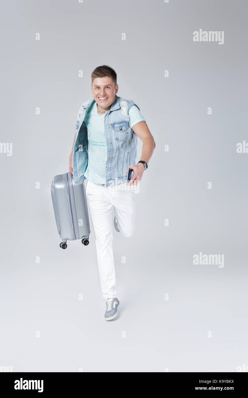 Man running suitcase in hand hi-res stock photography and images - Alamy