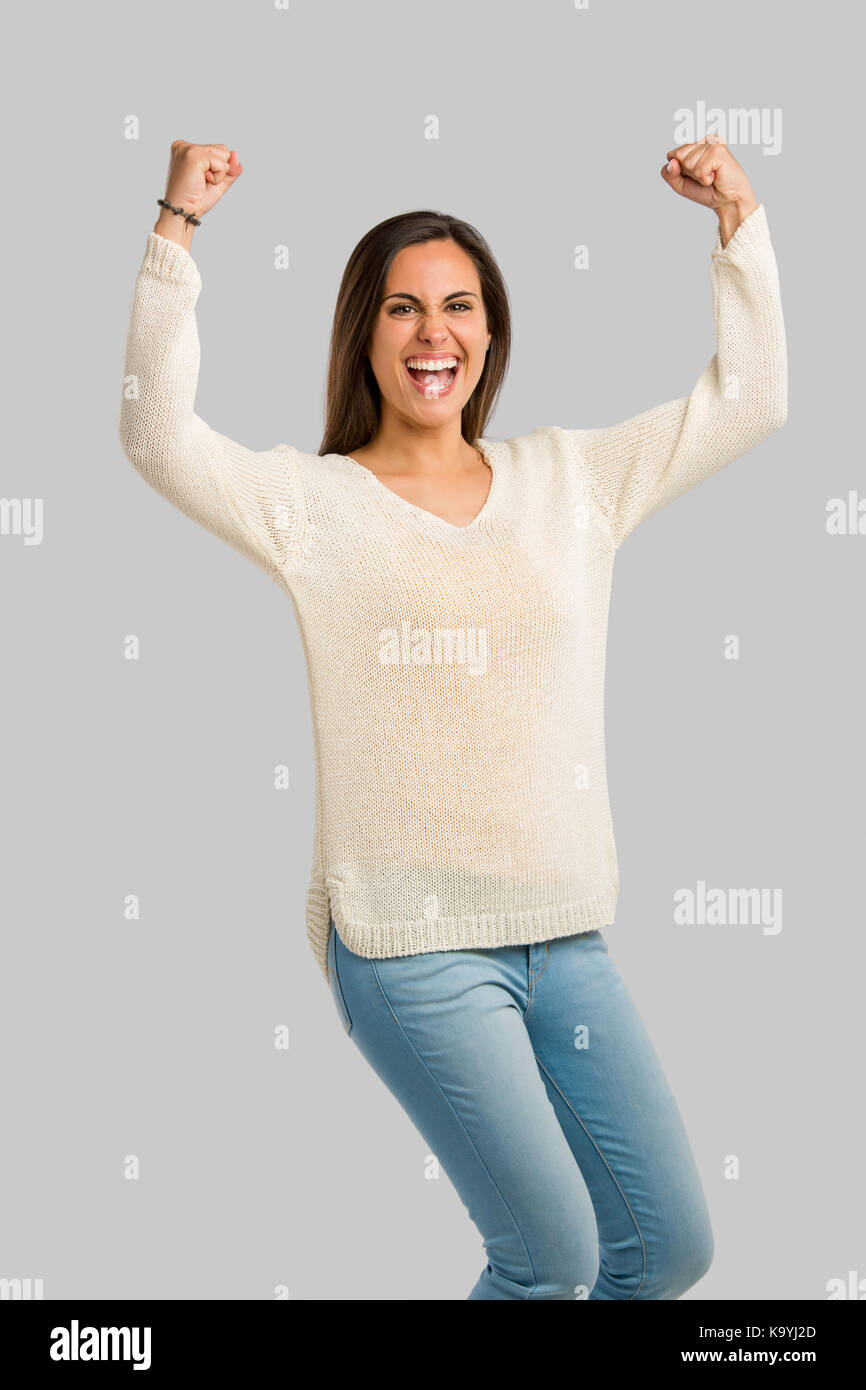Studio shot of a happy young woman with arms raised Stock Photo - Alamy