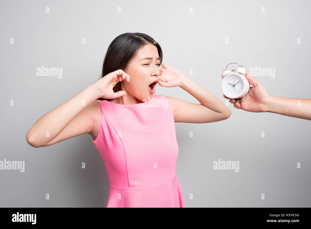 Scared young woman looking at camera over white background Stock Photo ...