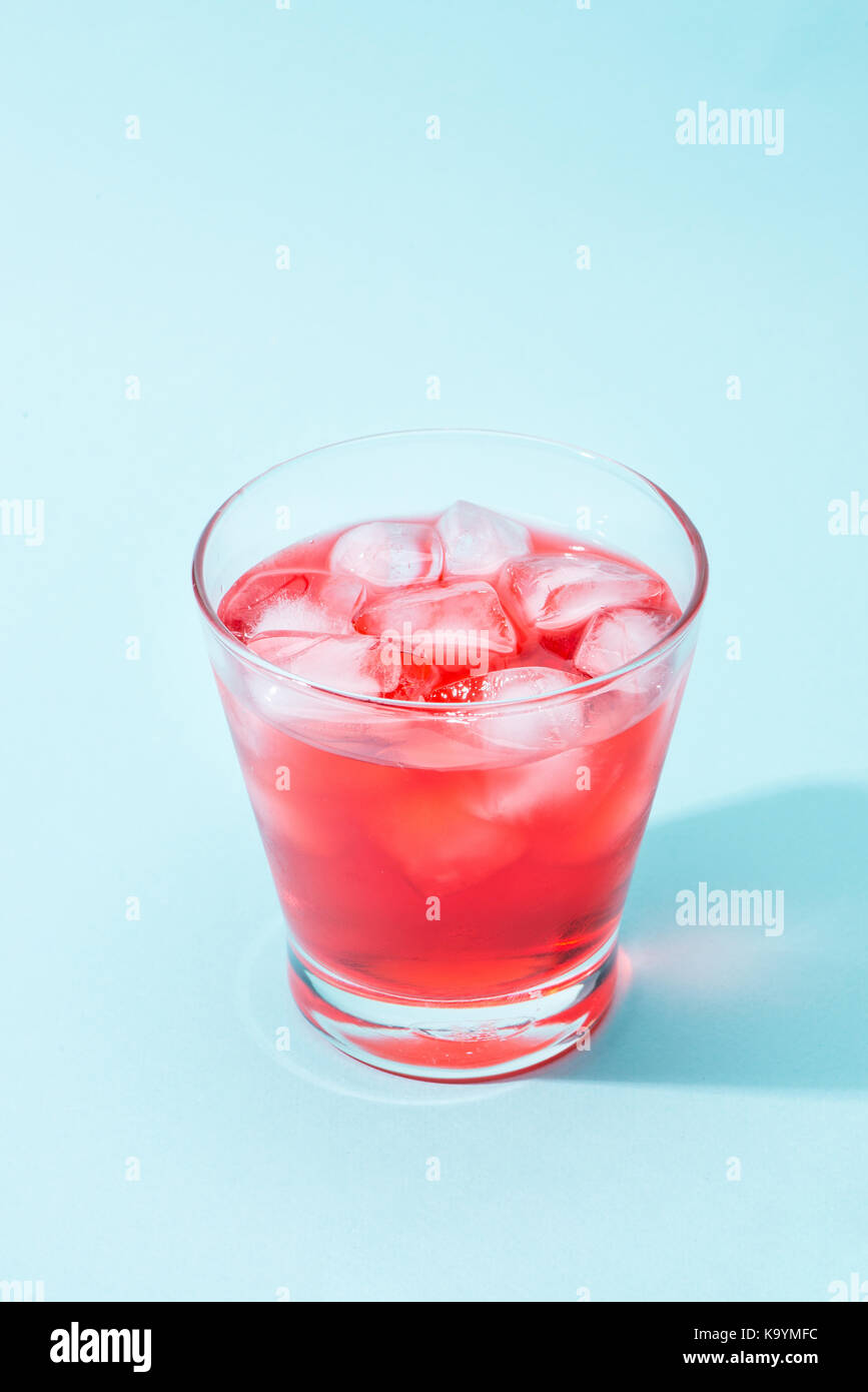 Sparkling red color drinks with water soda and ice in glass Stock Photo ...