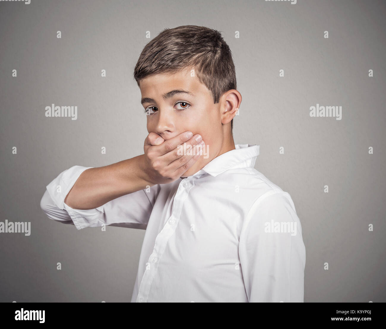 Portrait scared young handsome man looking surprised, hand covering ...