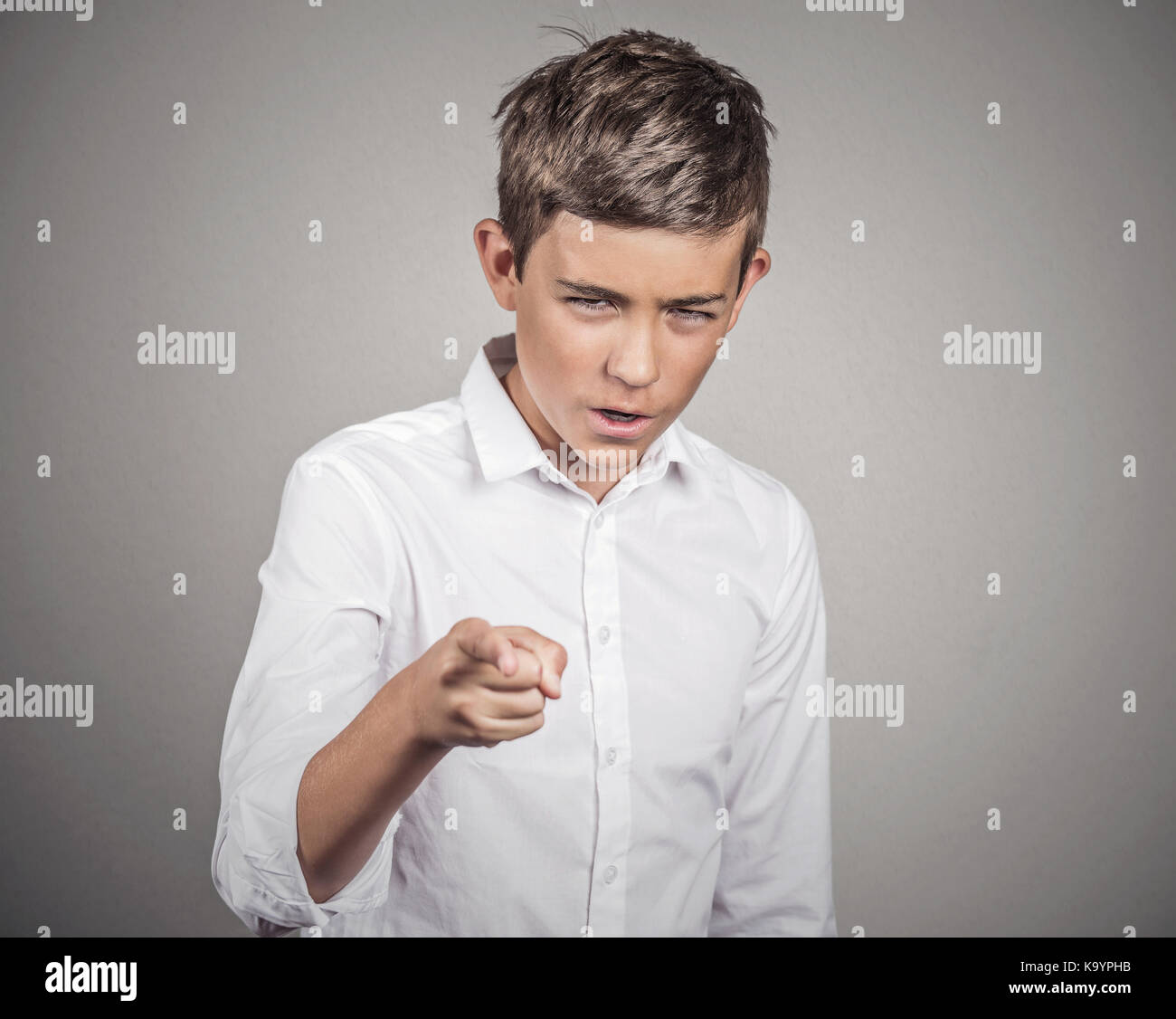 Portrait angry teenager, pointing finger at someone, displeased ...