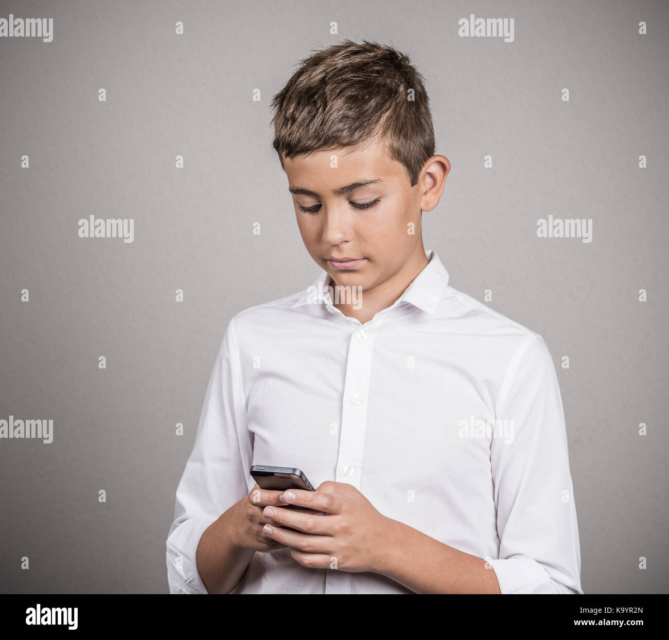 Important Text Message. Portrait Teenage boy looking on screen, reading ...