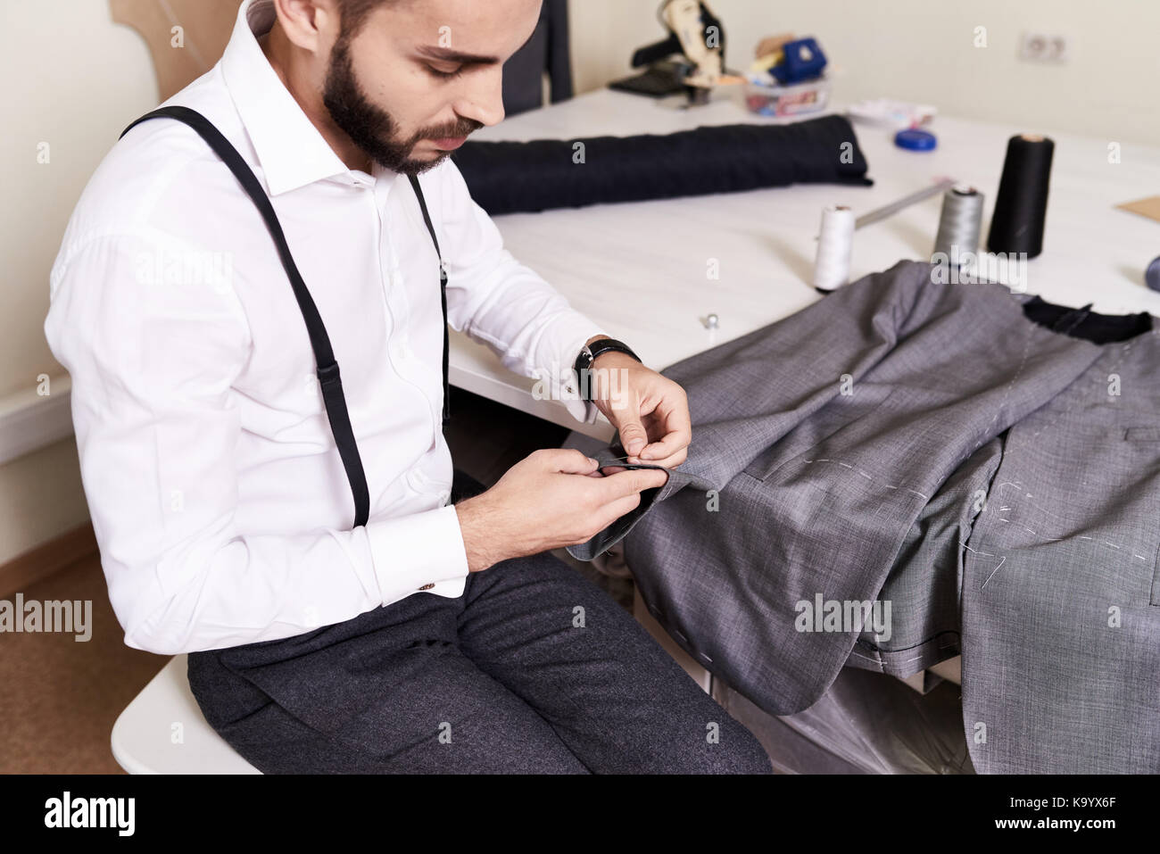Tailor sitting hi-res stock photography and images - Alamy