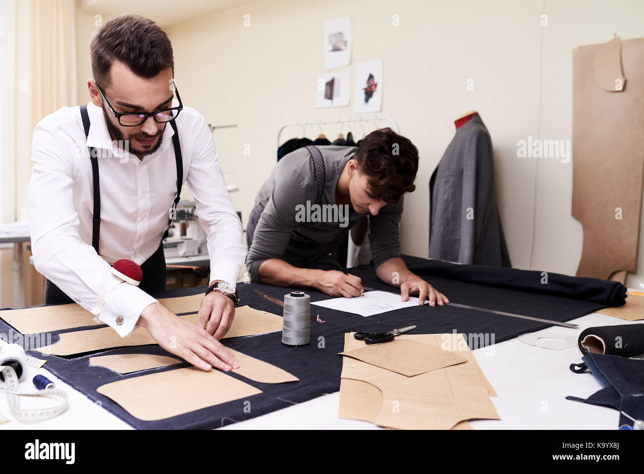 Gifted team of young designers gathered together at modern studio and ...