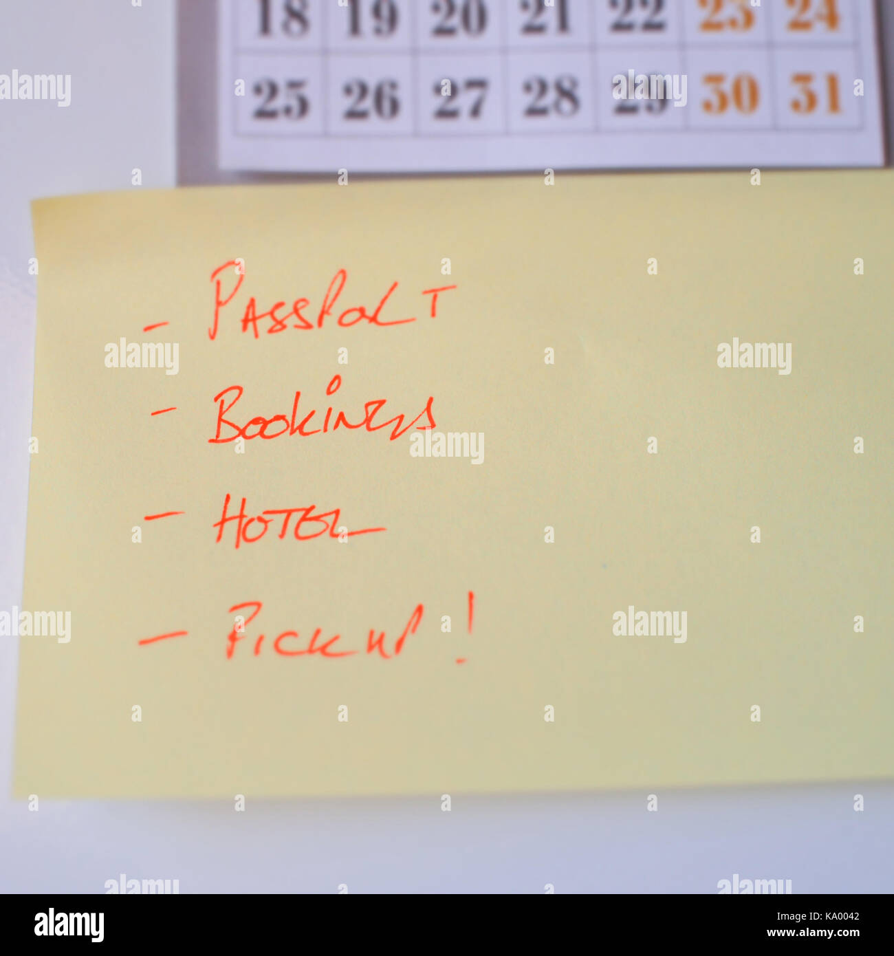 A yellow sticky note with handwritten travel reminders, including ...