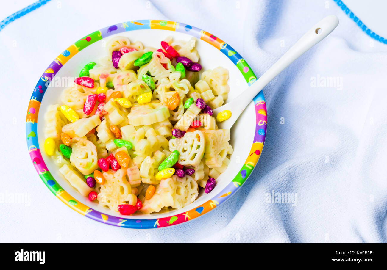 Shaped children pasta in colorful bowl tabletop Stock Photo - Alamy