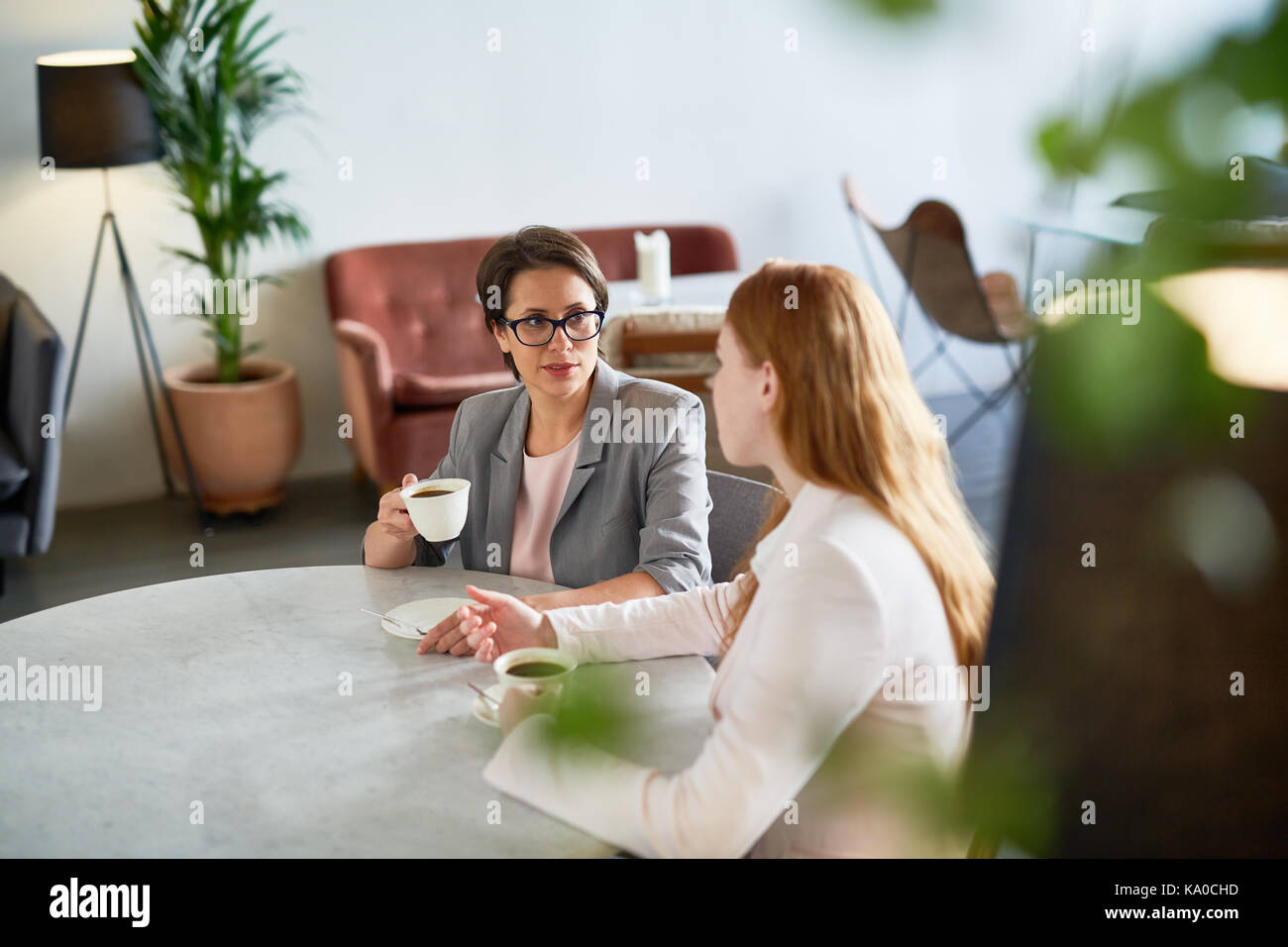Women talking in cafe Stock Photo - Alamy
