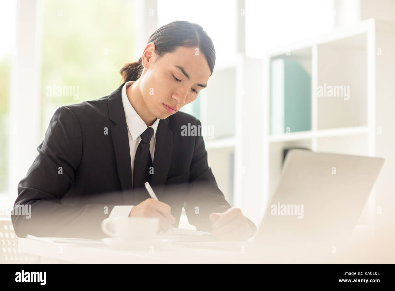 Young businessman taking notes working hi-res stock photography and ...