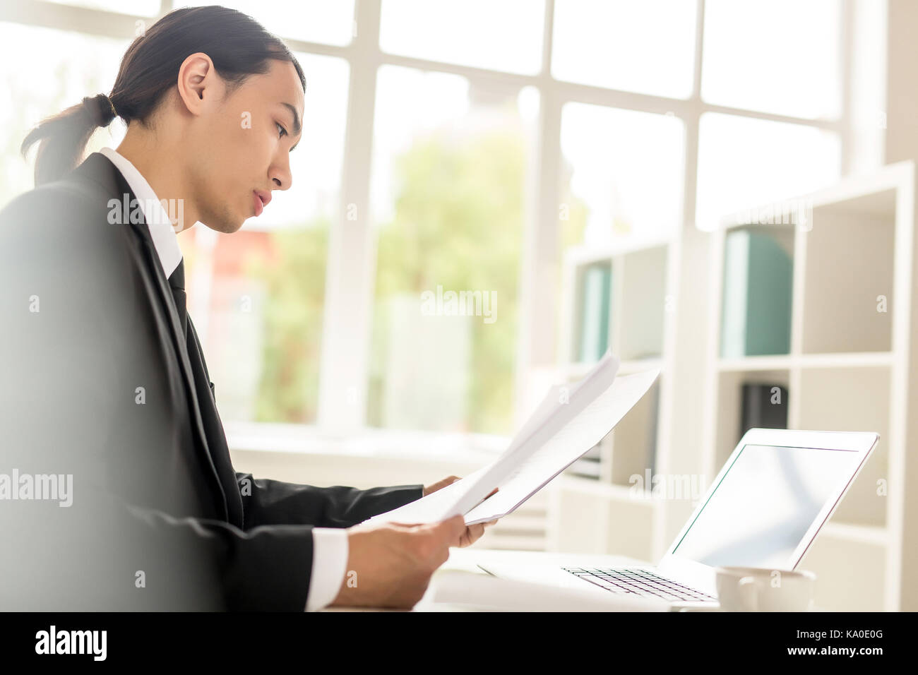 Asian Manager Focused on Work Stock Photo - Alamy