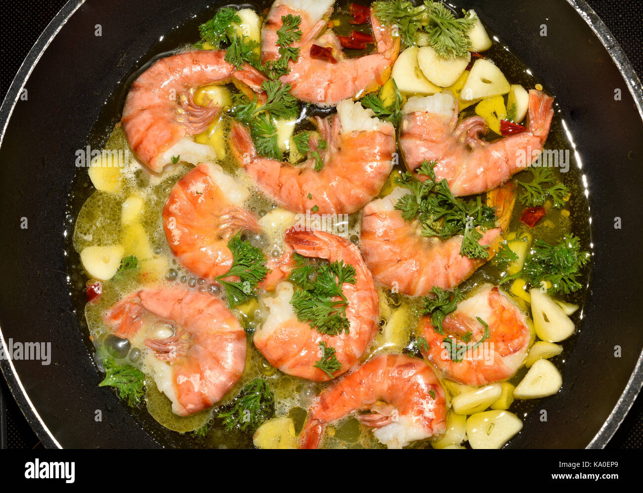King prawns, tiger shrimps, with garlic and parsley in a pan, Canary ...