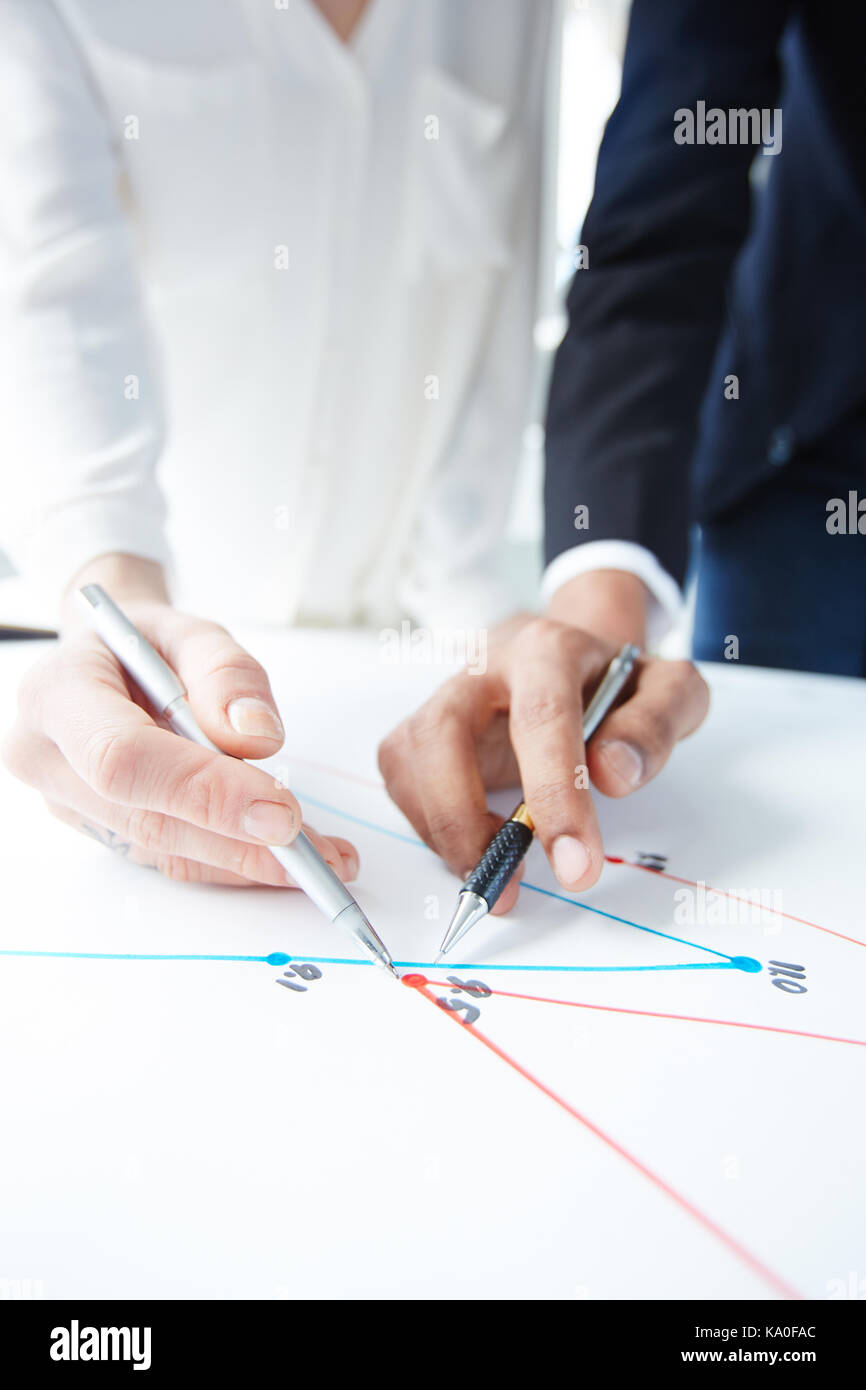 Discussing Business Graph with Colleague Stock Photo - Alamy