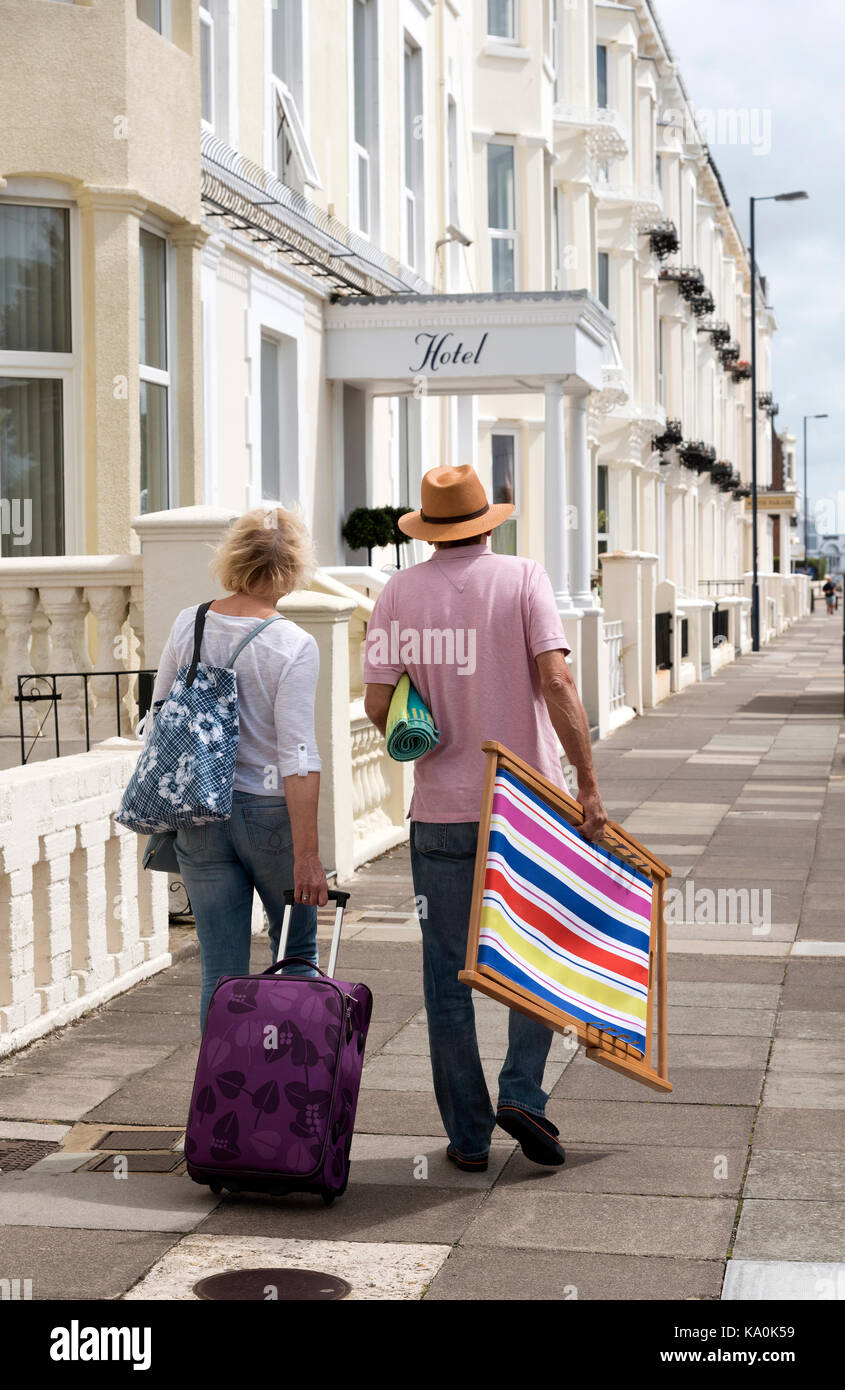 Holidaymakers in a seaside town walking to their hotel Stock Photo - Alamy