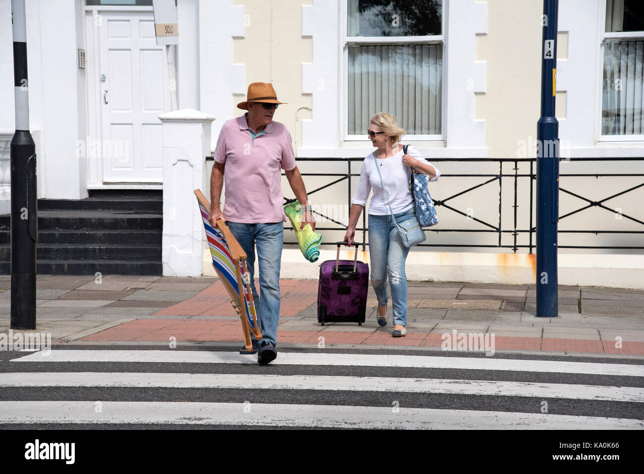 Holidaymakers using Zebra crossing to cross a road safely Stock Photo ...
