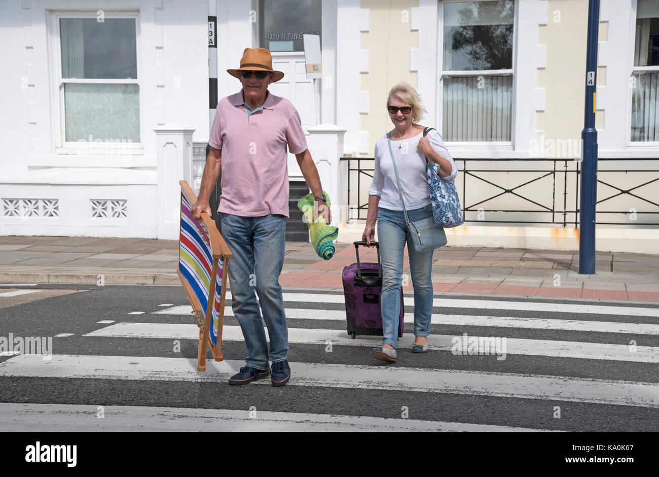 Holidaymakers using Zebra crossing to cross a road safely Stock Photo ...