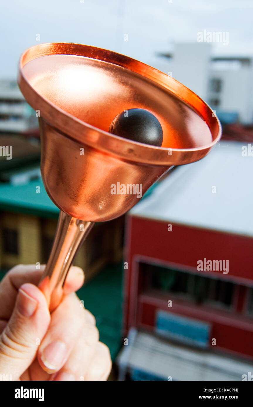 Indoor shot with outdoor background of someone (photographer) ringing a ...