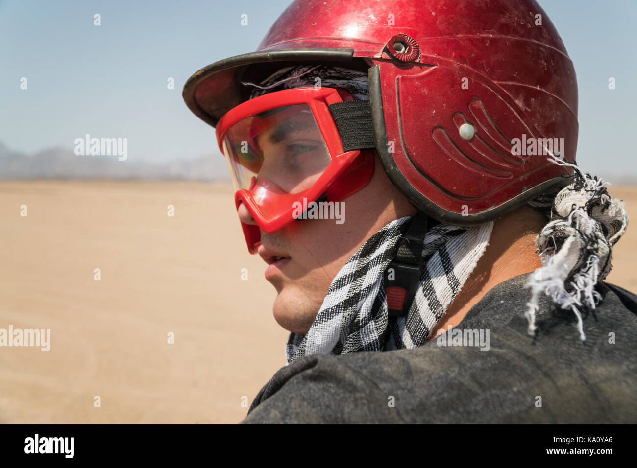 Young guy during desert excursion by quad - Man in helmet and adventure ...