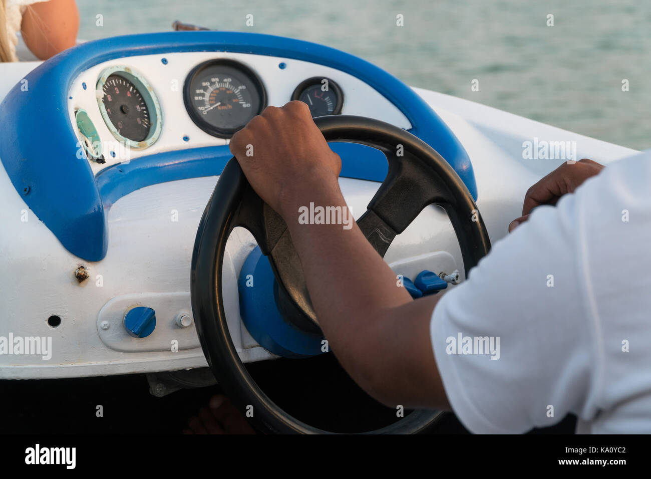Men's hands on the steering wheel of a motor boat Stock Photo - Alamy