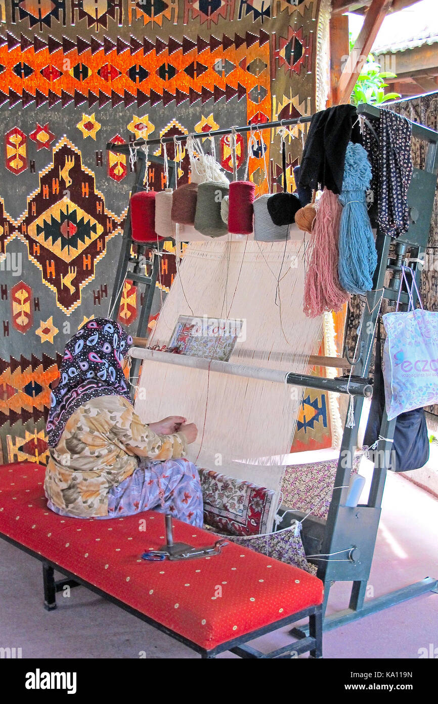 Turkish woman weaving carpets In Dalyan Stock Photo - Alamy