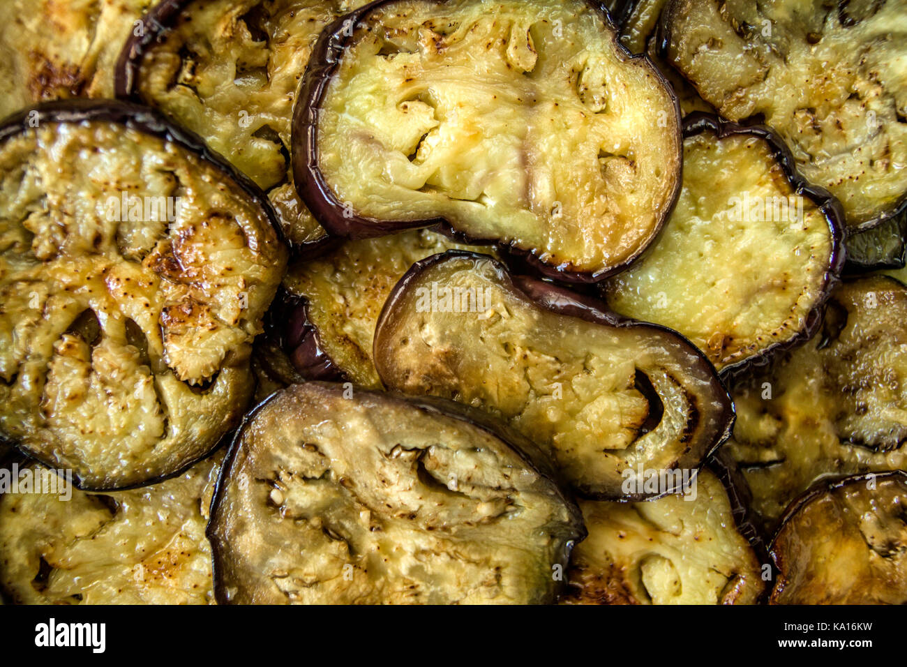 Fried and cooked aubergine with garlic in olive oil Stock Photo - Alamy