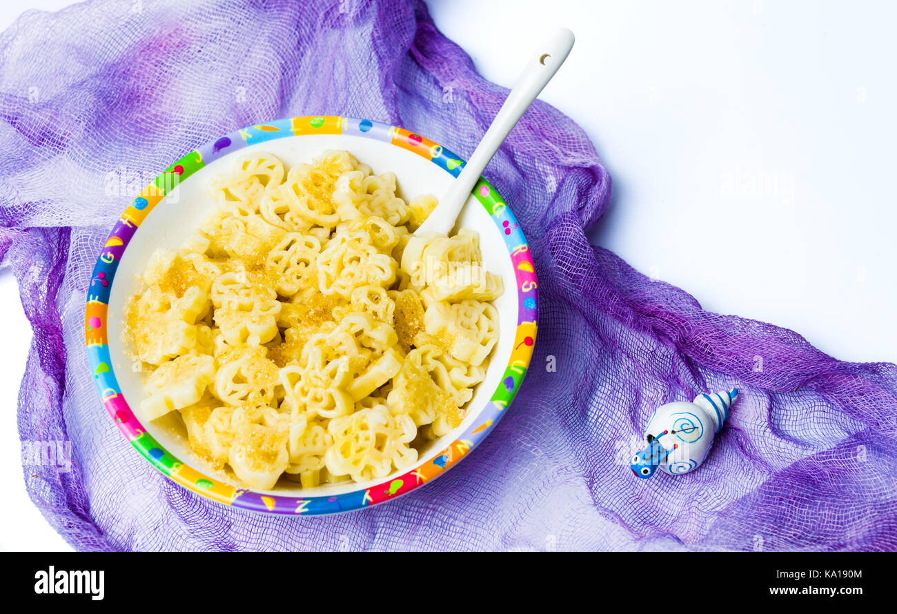 Shaped children pasta in colorful bowl tabletop Stock Photo - Alamy