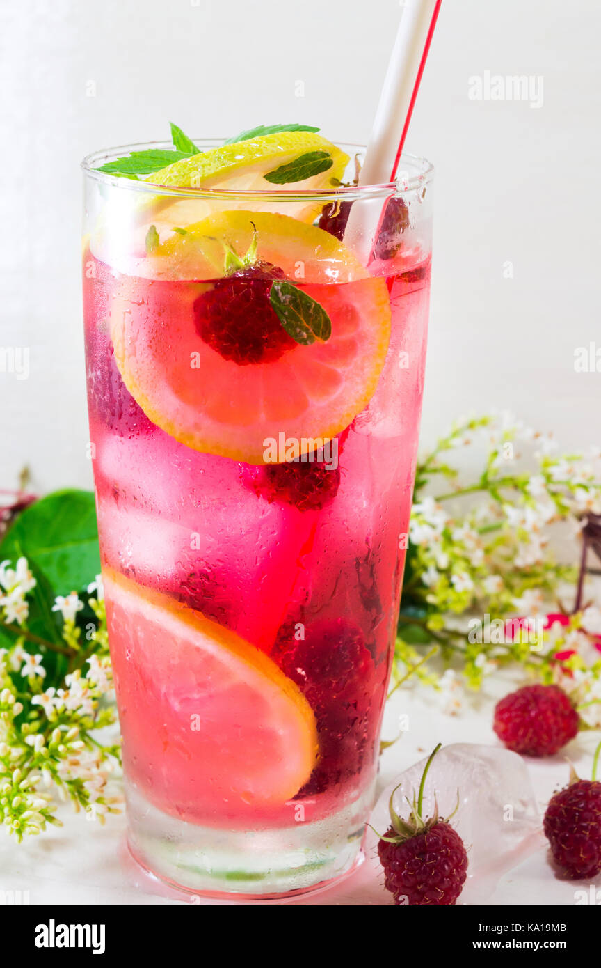 Raspberry juice with mint leafs and ice in a glass Stock Photo - Alamy