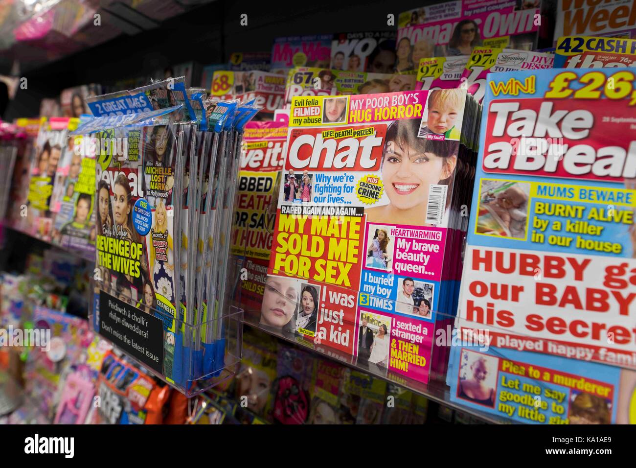 Magazines on display in a newsagent store Stock Photo - Alamy