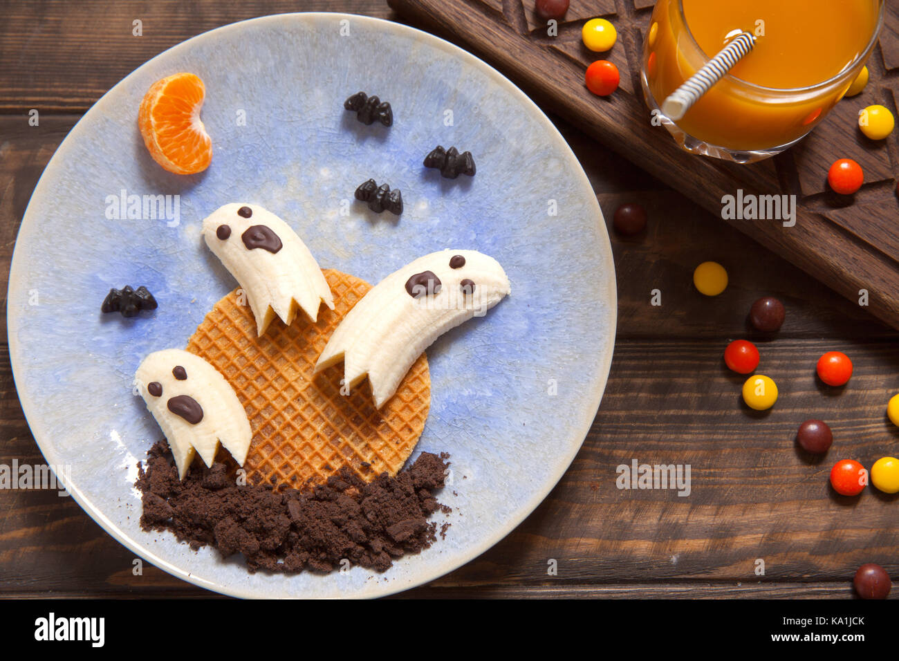 Scary halloween food edible banana ghosts with waffle Stock Photo - Alamy