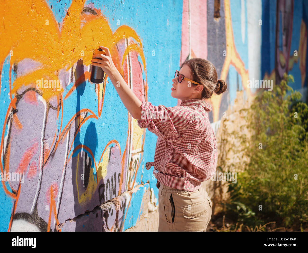 Female Graffiti Artist In Action