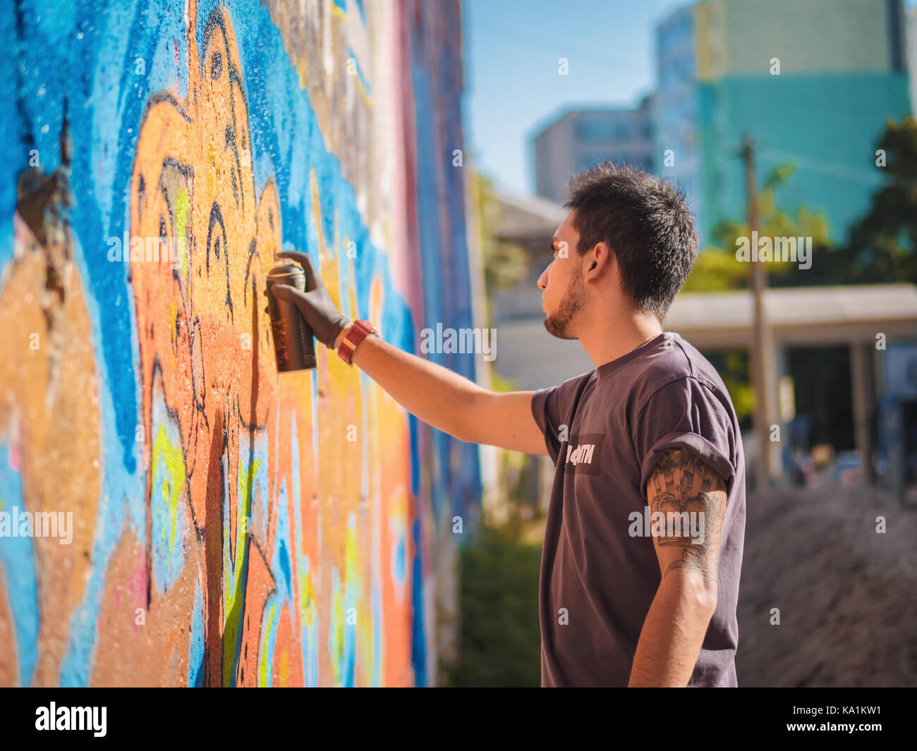 Handsome Talented Young Boy making a colorful graffiti with aerosol ...