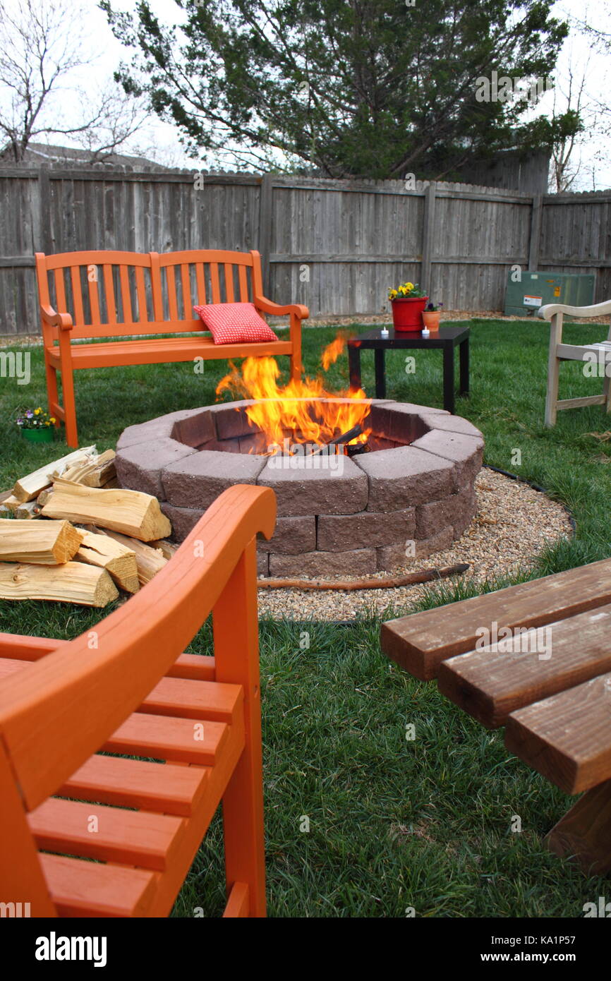 Backyard fire pit with wood benches gathered around Stock Photo - Alamy