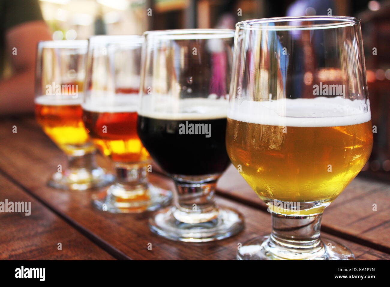 Flight of four beers on an outdoor picnic table Stock Photo - Alamy