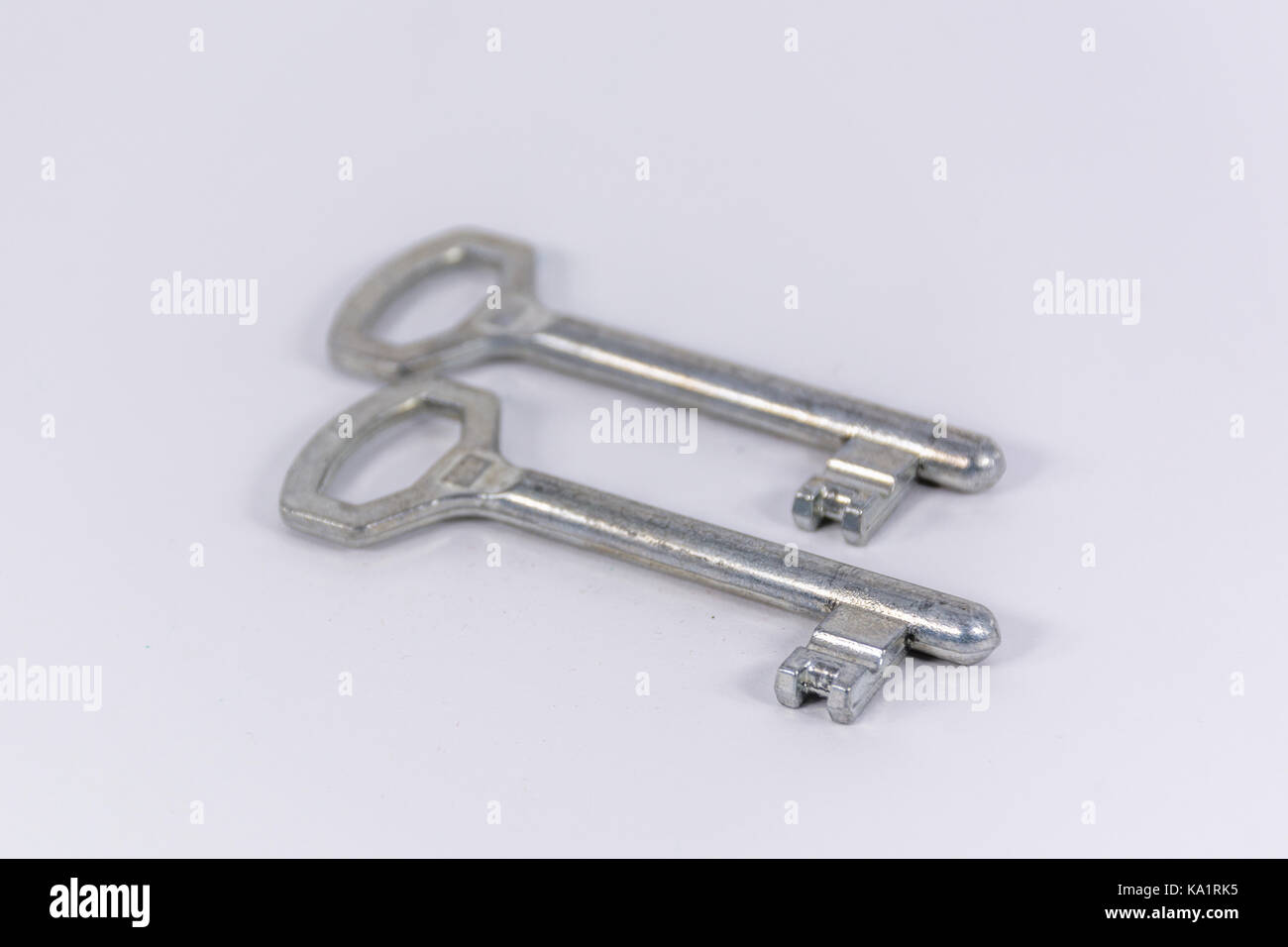 Pair of metal keys isolated on white background Stock Photo - Alamy