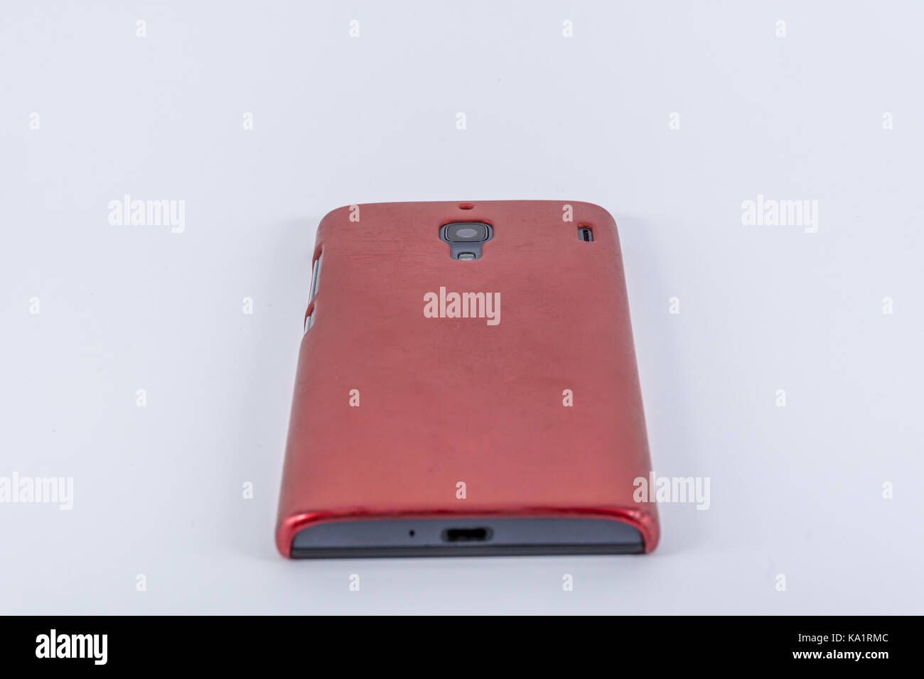Smartphone with red cover on white background Stock Photo - Alamy