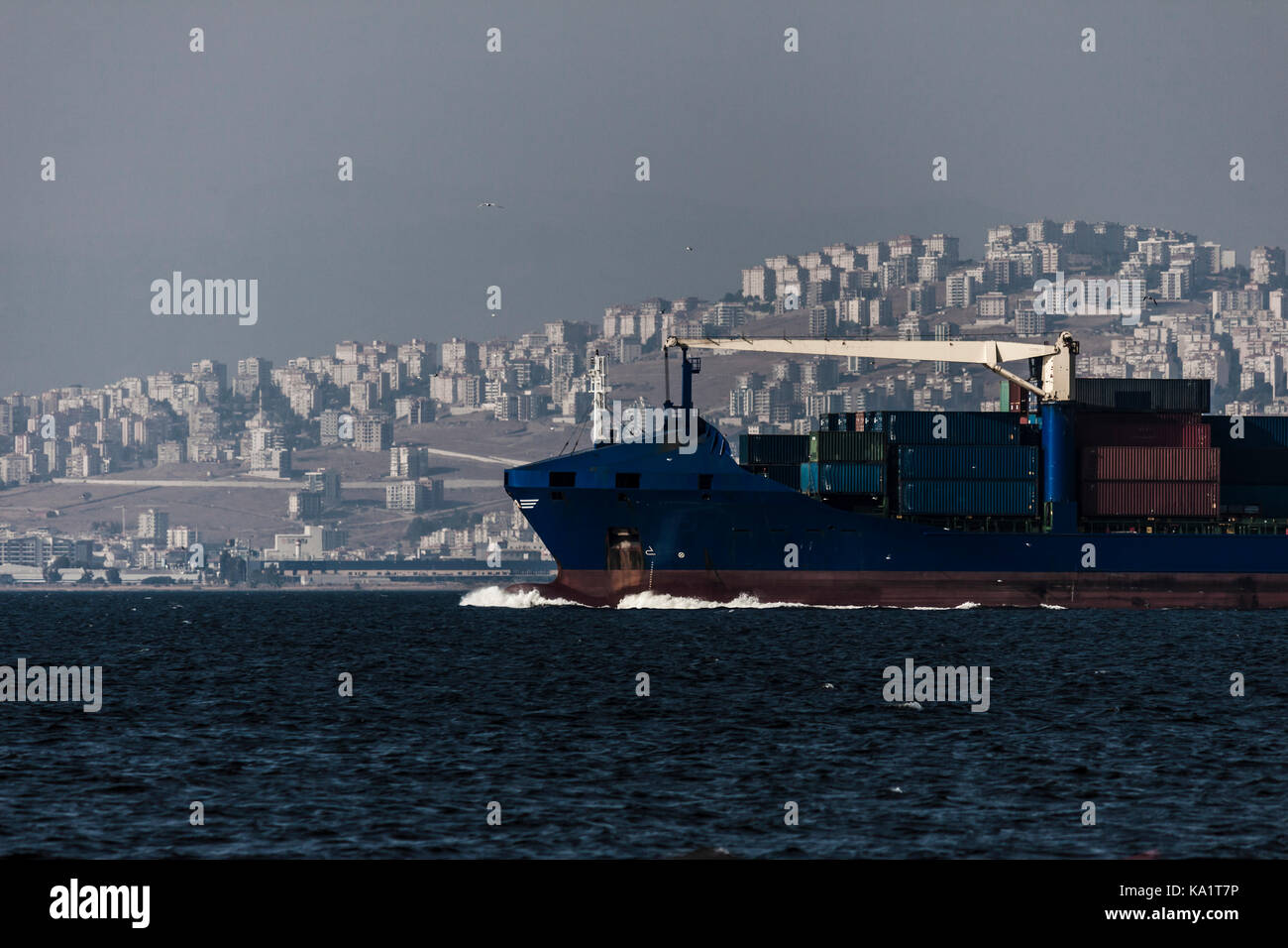 Boat full of containers on the sea in Izmir Stock Photo - Alamy